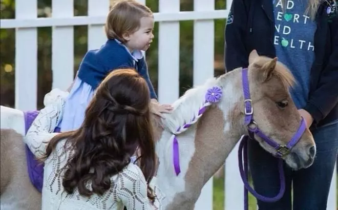 Kate Middleton, an Bhanríon Elizabeth II agus máithreacha eile ag súgradh le leanaí sa 